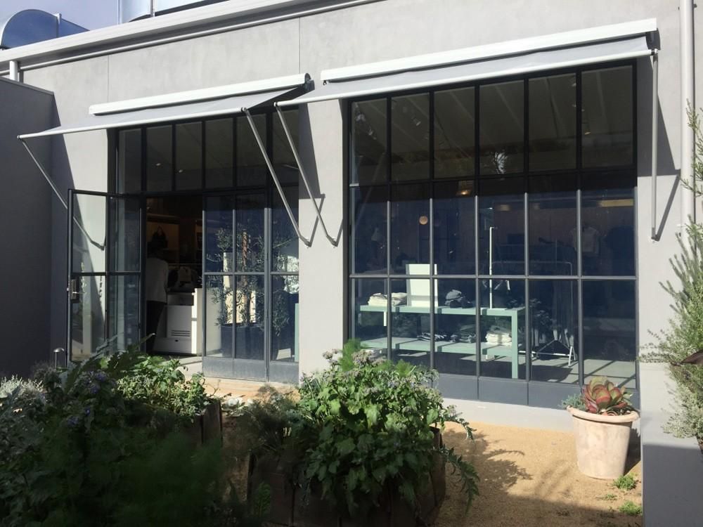 Privacy and attenuation of light in an attractive Drop-Arm Awning by Warema - Shade Factor